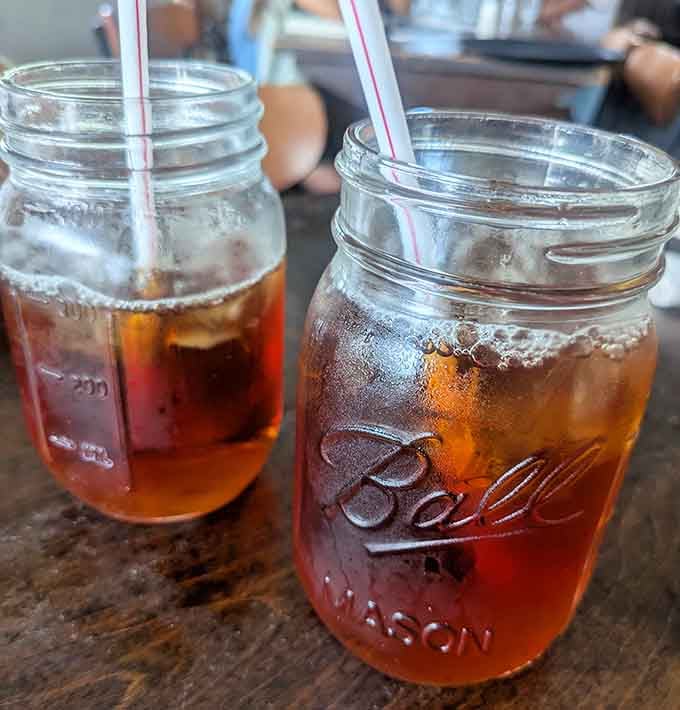 Mason jars filled with sweet tea, because some Southern traditions are too perfect to mess with.