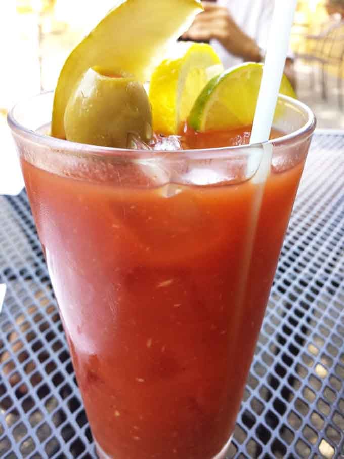 A Bloody Mary garnished so generously it doubles as both drink and appetizer, solving two problems simultaneously here.