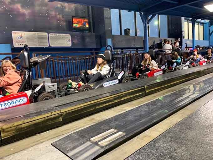 Go-karts lined up and ready to transform ordinary families into competitive racing rivals within approximately thirty seconds of starting.