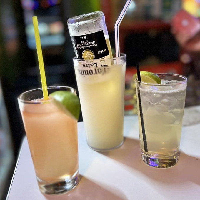 Margaritas that arrive ready for their close-up, because presentation matters even in dive bar heaven.