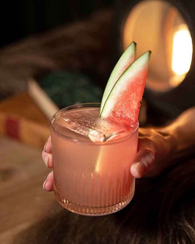 Fresh watermelon slices stand at attention like delicious soldiers guarding a pink paradise you'll want to sip slowly.