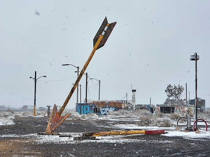 Winter snow dusts the arrows, proving these sentinels stand watch through every Arizona season imaginable.