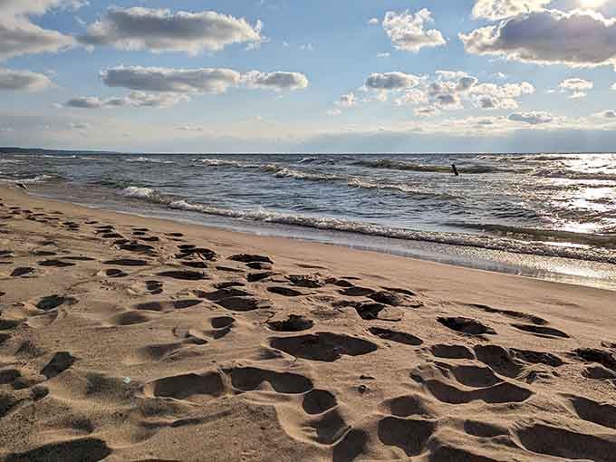 Footprints in the sand tell stories of beach walks, proving someone else discovered this gem before you.