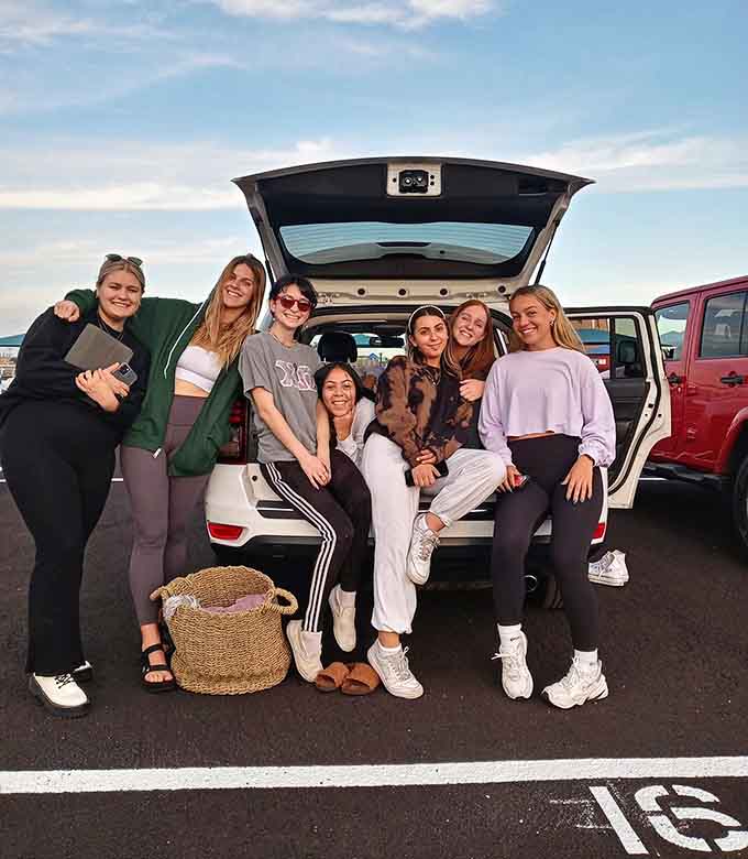 Friends gathering at the tailgate proves the best theater seats are the ones you bring yourself.