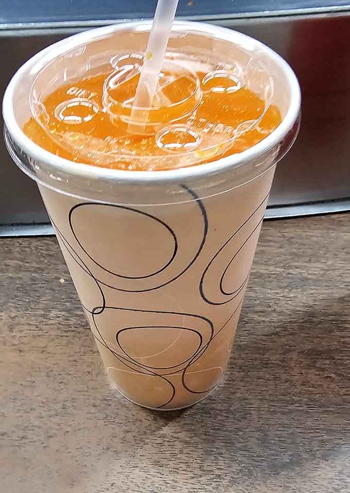Orange soda never looked so good, served in a classic cup that screams vintage diner vibes.