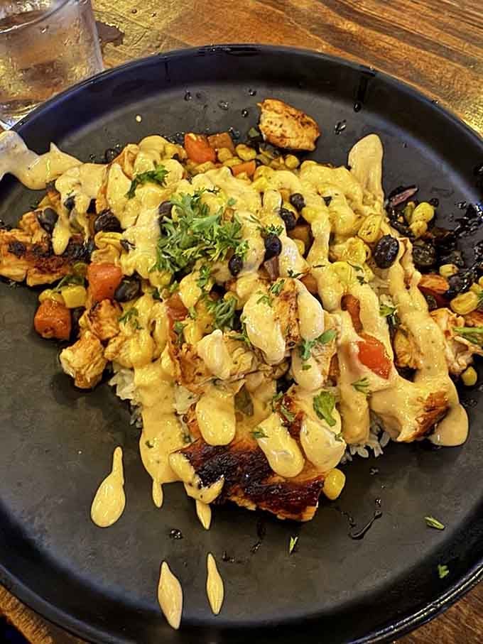 This colorful chicken bowl brings Southwest flair to your table, loaded with fresh vegetables and drizzled with creamy sauce perfection.