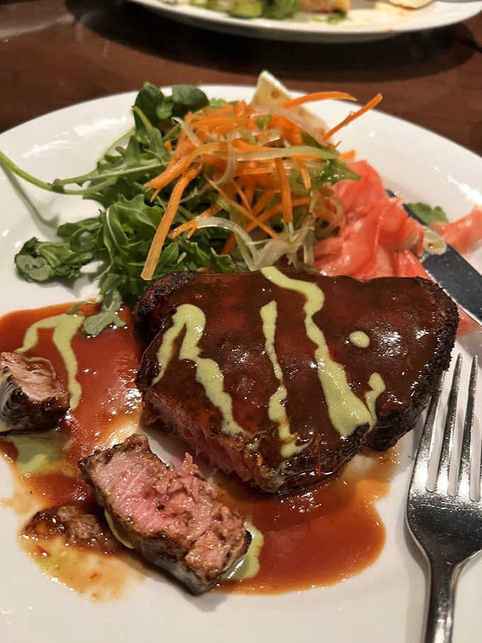 Blackened ahi tuna sliced thick and seared rare shows this kitchen handles seafood with equal expertise.