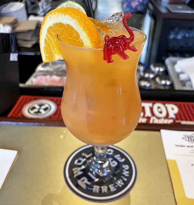 A tropical escape in a glass, complete with a tiny dinosaur because why should kids have all the fun?