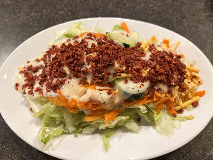 A loaded salad with bacon bits and all the fixings, because even steakhouses know vegetables deserve respect.