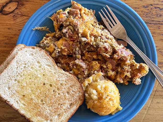 The Oinker Scramble arrives looking like breakfast decided to throw itself a proper party on your plate.