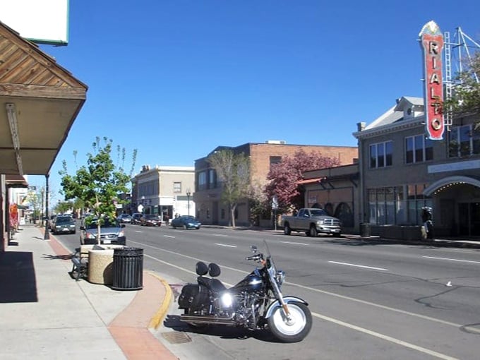 That vintage Rialto sign glows as evening light paints historic buildings in warm hues worth savoring slowly.