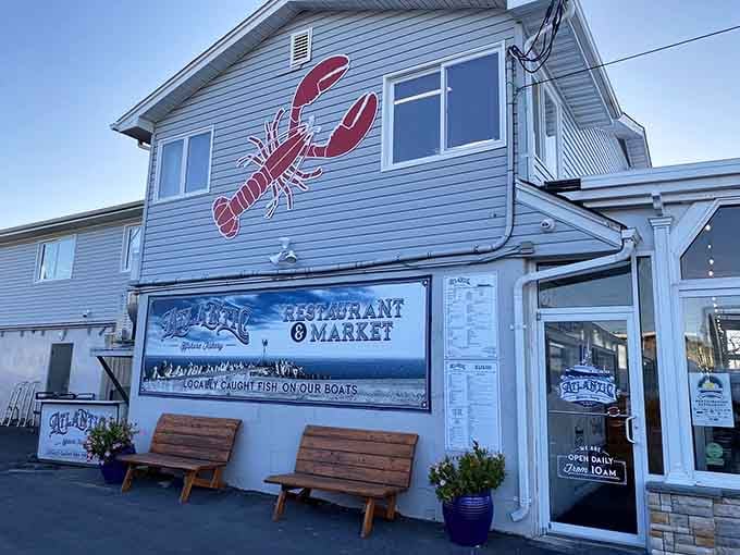 That giant red lobster mural announces loud and proud exactly what awaits you inside this authentic waterside seafood destination.