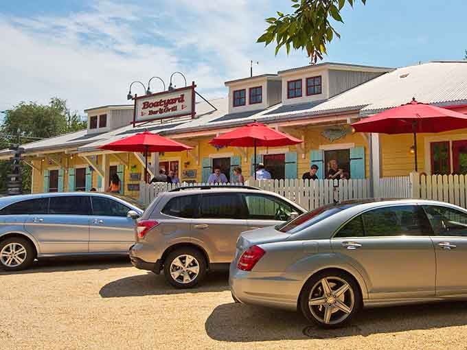 Bright yellow siding and cheerful red umbrellas create a festive atmosphere that screams "summer vacation starts here!"