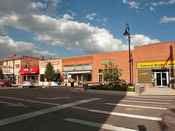 Tree-lined streets soften the brick buildings, creating pleasant shade for sidewalk strolls on warm Colorado afternoons that last forever.