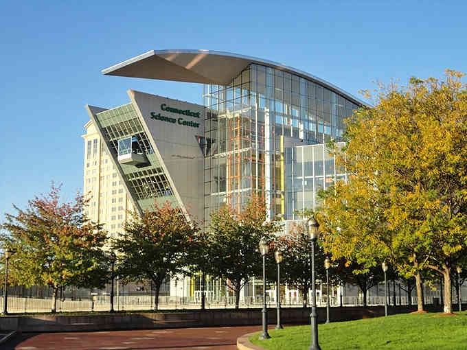 Modern glass architecture gleams in golden afternoon light, its bold angles suggesting the innovative discoveries waiting inside these walls.