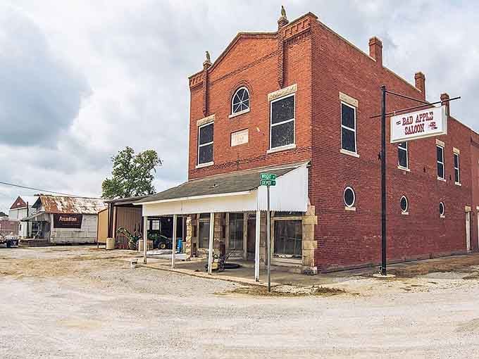That brick corner building stands like a sentinel watching over generations of small-town stories unfold daily.