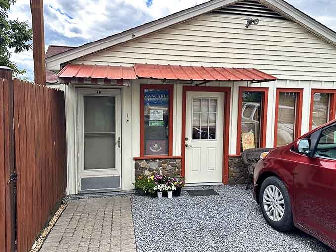 Cozy cottage exterior with coral-red trim makes this chocolate shop feel like a delicious secret hideaway.
