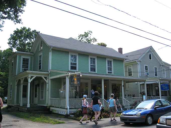 Visitors stroll past the mint-green Victorian like they're extras in a Hallmark movie about discovering charming New England towns.