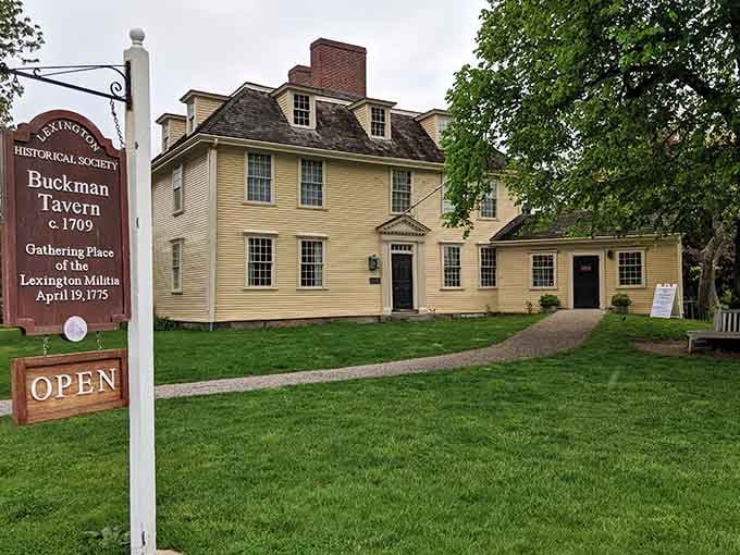 The Buckman Tavern stands ready, its butter-yellow walls holding secrets from the day the Revolution began on these grounds.
