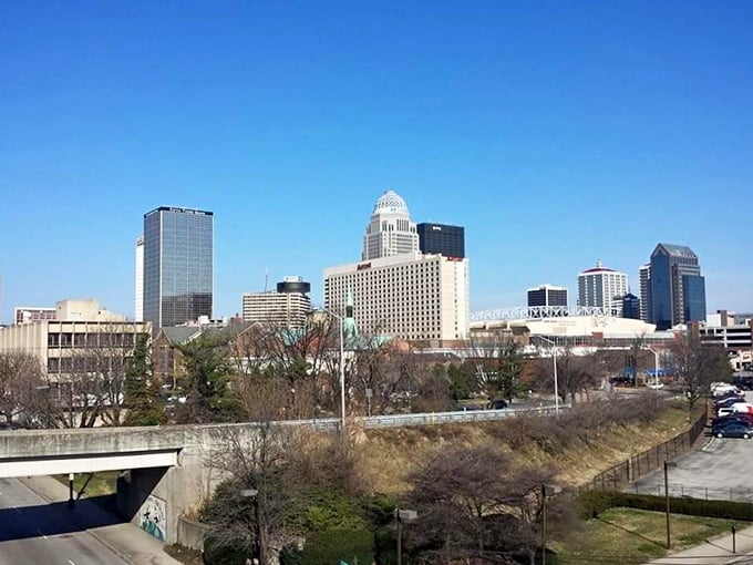 The city skyline rises confidently, blending Kentucky's river town roots with modern metropolitan ambition and energy.