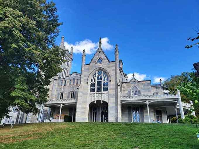 Gothic windows pierce pale stone walls, creating drama that would make any Victorian novelist reach for their writing desk.