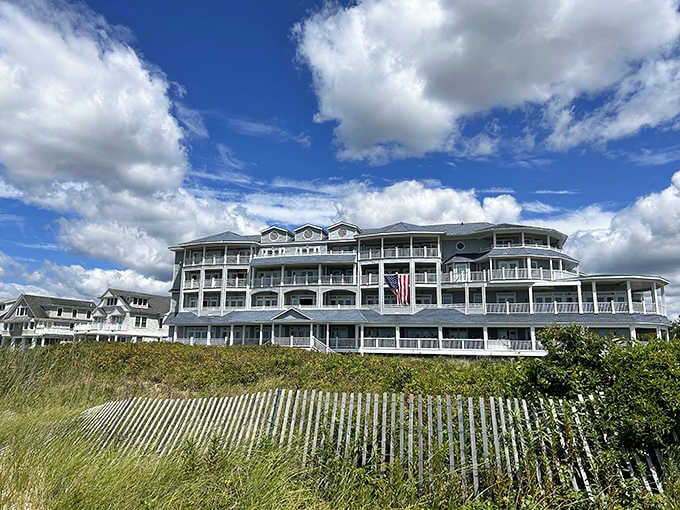Beach grass sways in the foreground while this grand hotel rises majestically, promising elegant dining with ocean views.
