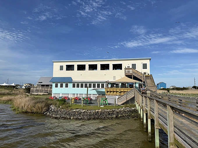 This two-story waterfront beauty sits right where marsh meets sky, offering views that make every meal special.