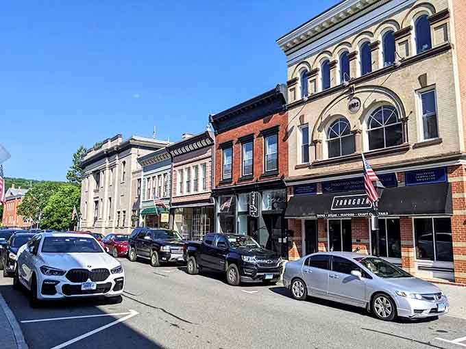 Explore the vibrant, bustling atmosphere of downtown New Milford, where historic buildings meet modern energy along this lively street.