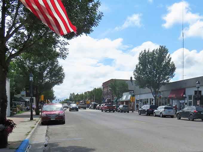 Patriotic flags wave above storefronts where local businesses still thrive and neighbors support each other daily.