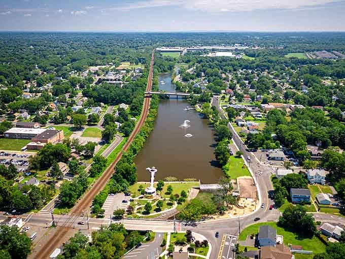 The waterway cuts through town like a liquid highway, reflecting clouds while boats drift lazily past riverside homes.