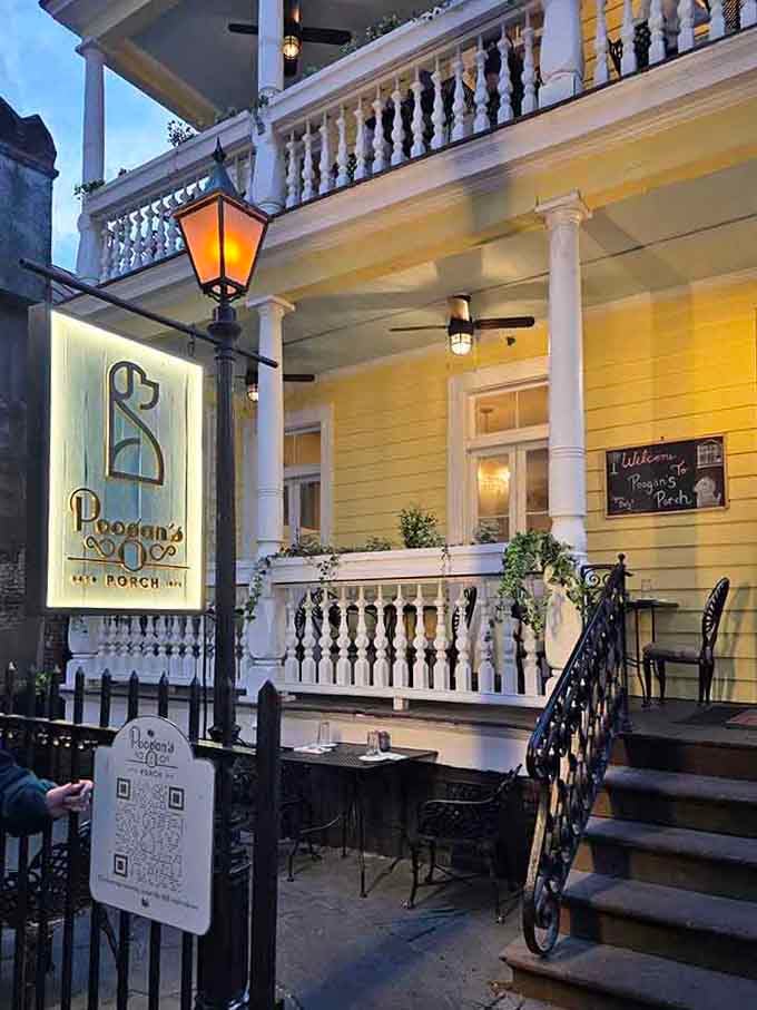 Gas lanterns and elegant ironwork frame this historic porch, where Southern hospitality has been perfected over many years.