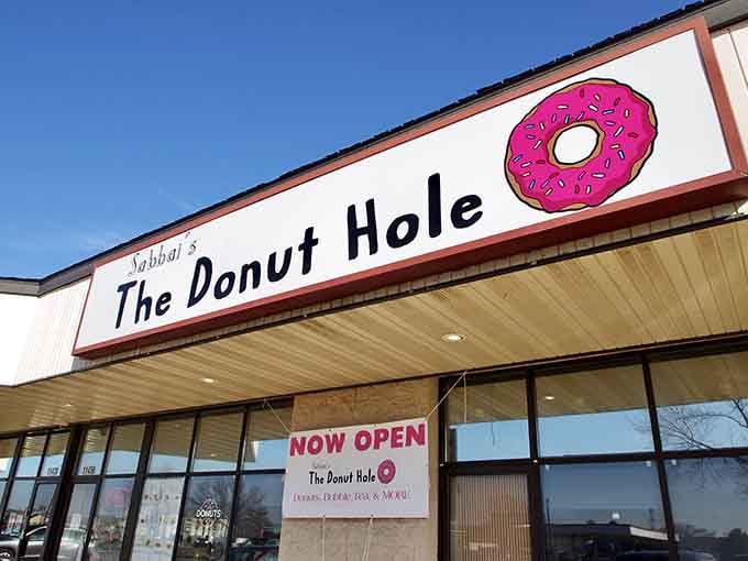 That cheerful pink donut graphic against crisp white makes your mouth water before you even step inside the door.
