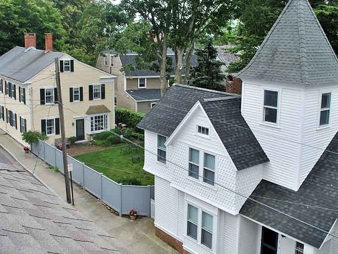 Rooftops nestle together like puzzle pieces while chimneys reach skyward competing to see who can touch clouds first.