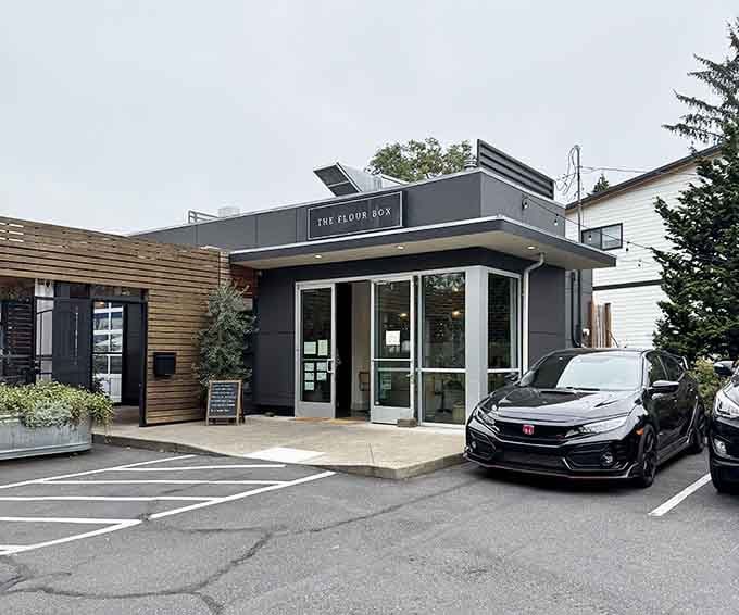 Sleek charcoal exterior with clean lines proves that donut shops can be both sophisticated and wonderfully welcoming simultaneously.