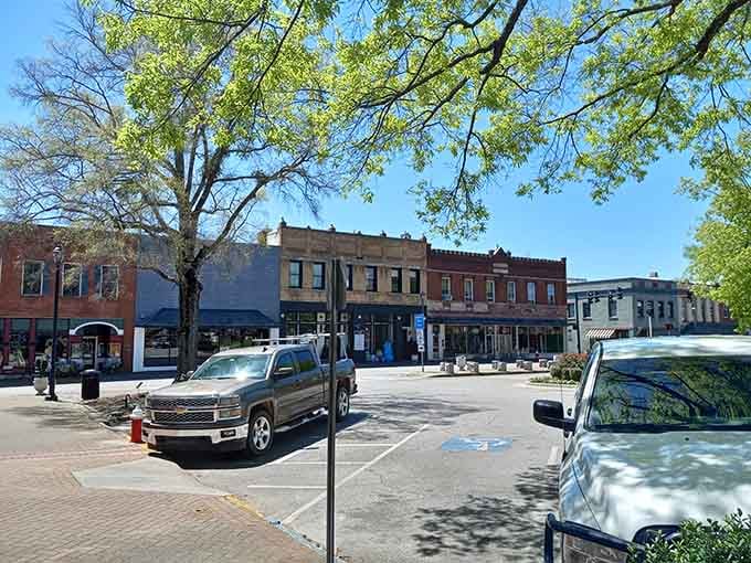 Classic storefronts stretch along Main Street where shopping means supporting neighbors, not faceless corporations selling mass-produced goods.