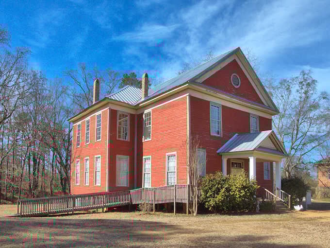 Coral-colored walls glow against bare winter trees, this stately building's cheerful paint somehow making the emptiness feel even stranger.