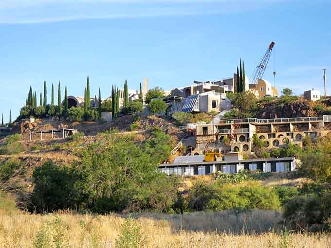 Terraced structures cascade down the hillside, blending futuristic vision with ancient pueblo wisdom in unexpected ways.