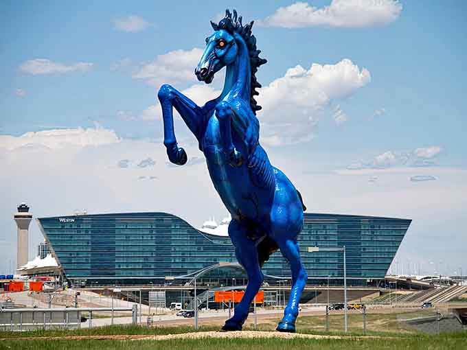 The massive mustang stands proud in daylight, its muscular form and bold color making it impossible to ignore or forget.