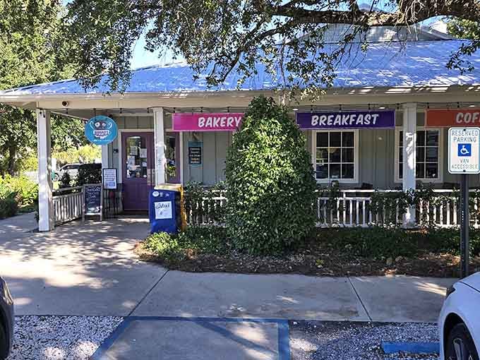 Shaded pathways and cheerful storefronts create the perfect setting for coffee, pastries, and lazy morning conversations.