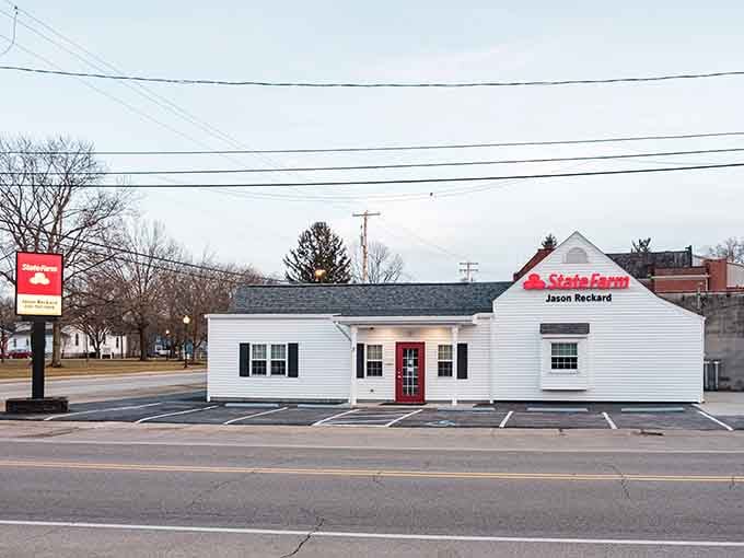 Classic white cottage with that bright red door&mdash;proof that small-town businesses still know how to welcome you home.