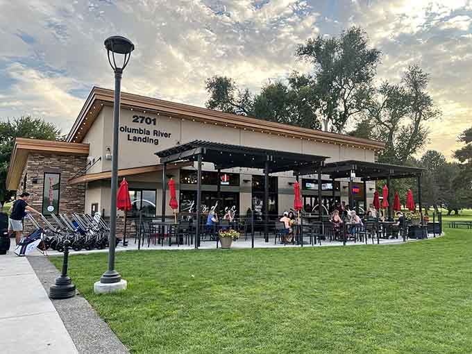 Diners fill the outdoor tables under a painted sky, united in their ambitious quest to conquer towering burgers.
