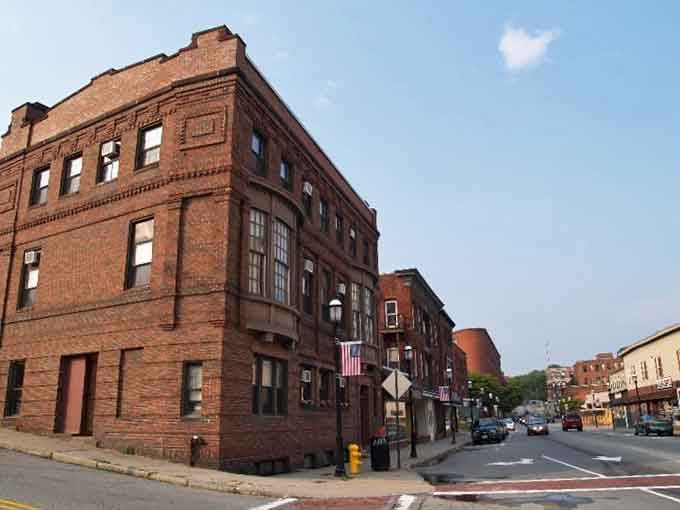 Patriotic flags wave from corner buildings where community pride runs deeper than any ocean you'll find nearby.