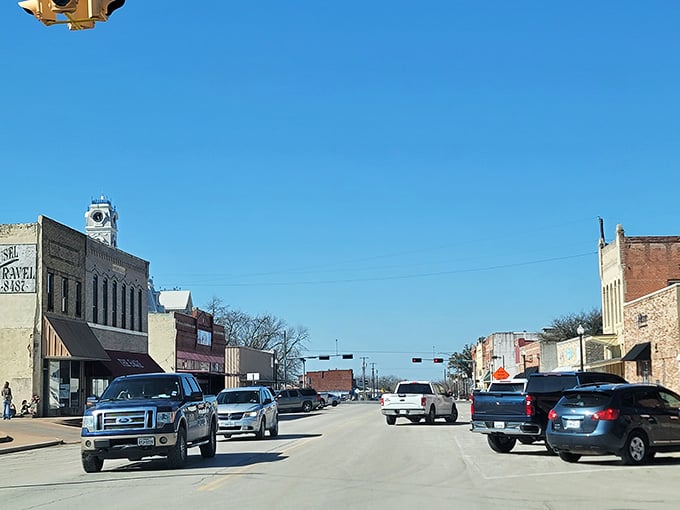 Main Street stretches ahead with that perfect small-town rhythm where traffic lights actually seem like a reasonable pace of life.