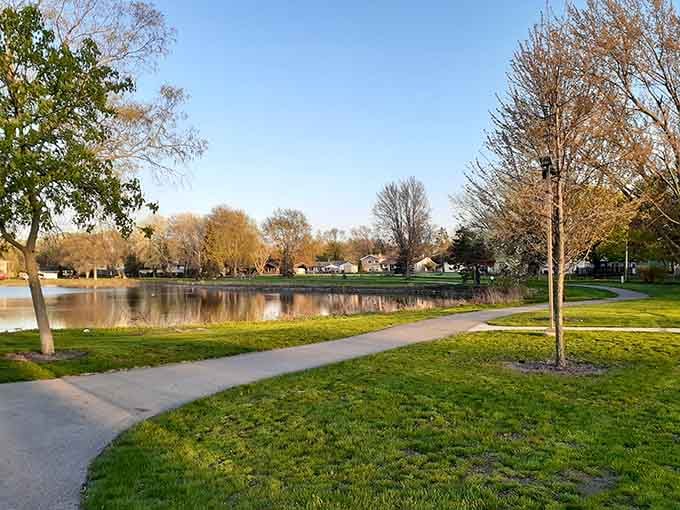 Walking paths wind past calm waters where morning joggers and evening strollers share friendly nods in passing.