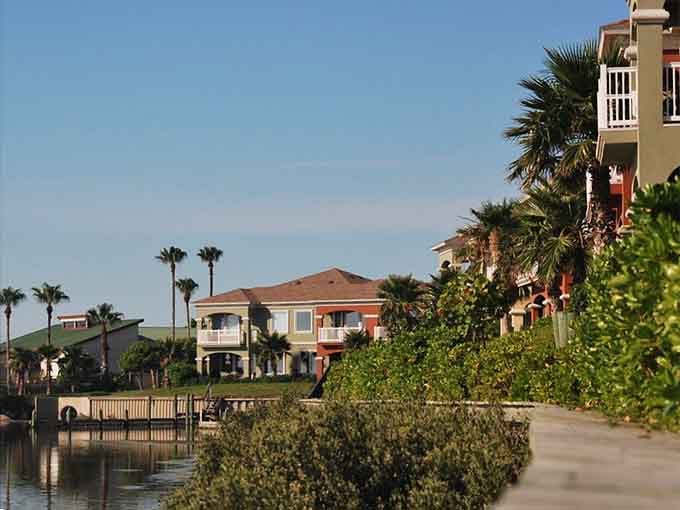 Palm trees sway along the canal where neighbors can wave to each other from their peaceful waterside retreats.