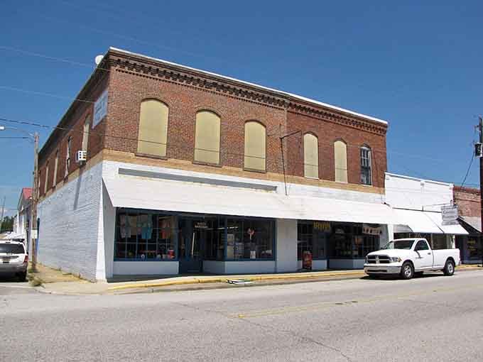 That two-story brick building stands solid and dependable, anchoring the corner like a trusted friend.