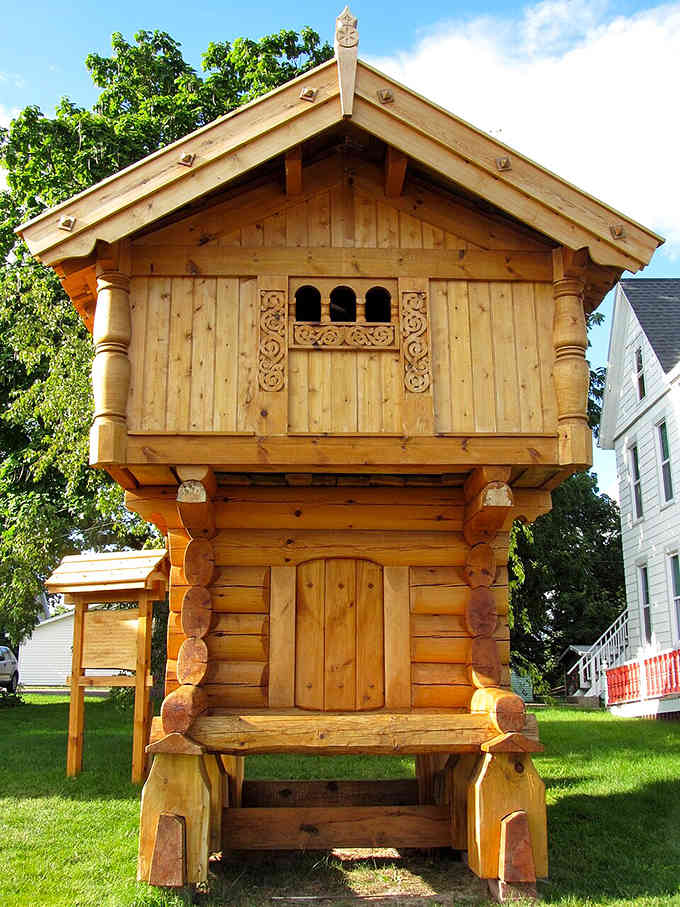 Hand-carved wooden details transform this structure into folk art, every surface telling stories through intricate craftsmanship and traditional Norwegian design.