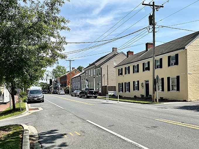 Simple colonial homes line the quiet street, their shutters and symmetry representing an era when craftsmanship mattered most.