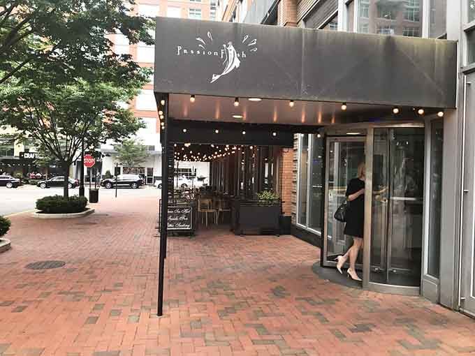 The modern awning and brick sidewalk create an inviting urban oasis where sustainable catches meet creative culinary passion.