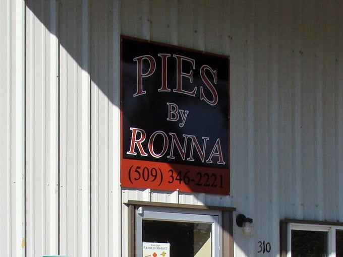 That bold red and black sign announces handmade pies with the confidence of someone who knows their crust game.